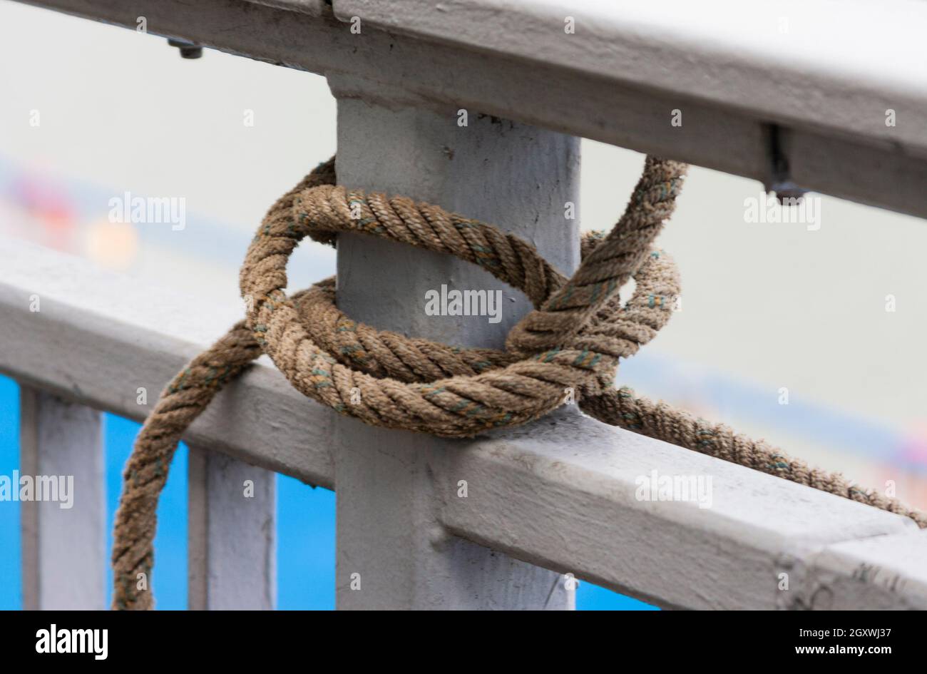 The photo shows a twisted rope on a metal railing Stock Photo - Alamy
