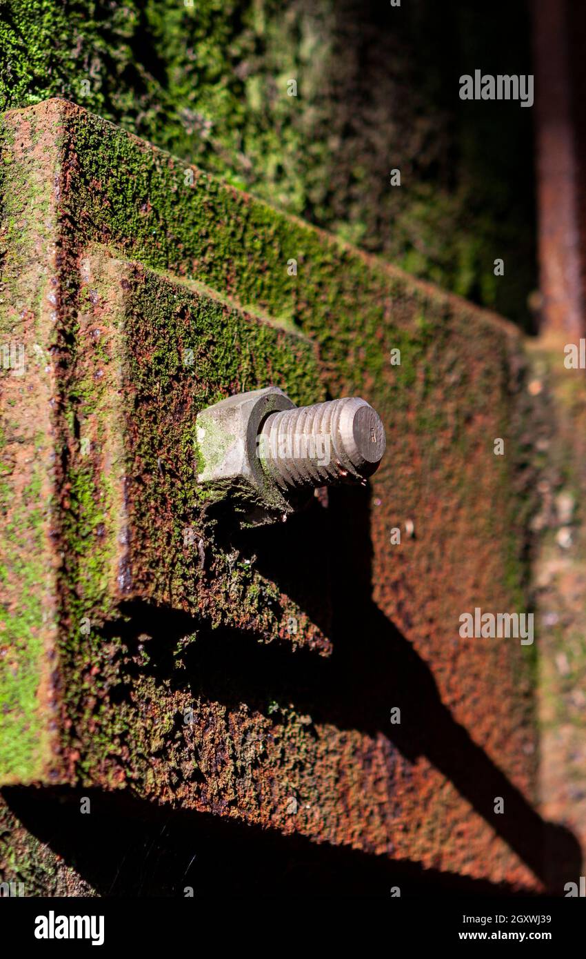 The photo shows a rusted steel bracket with a screw Stock Photo - Alamy