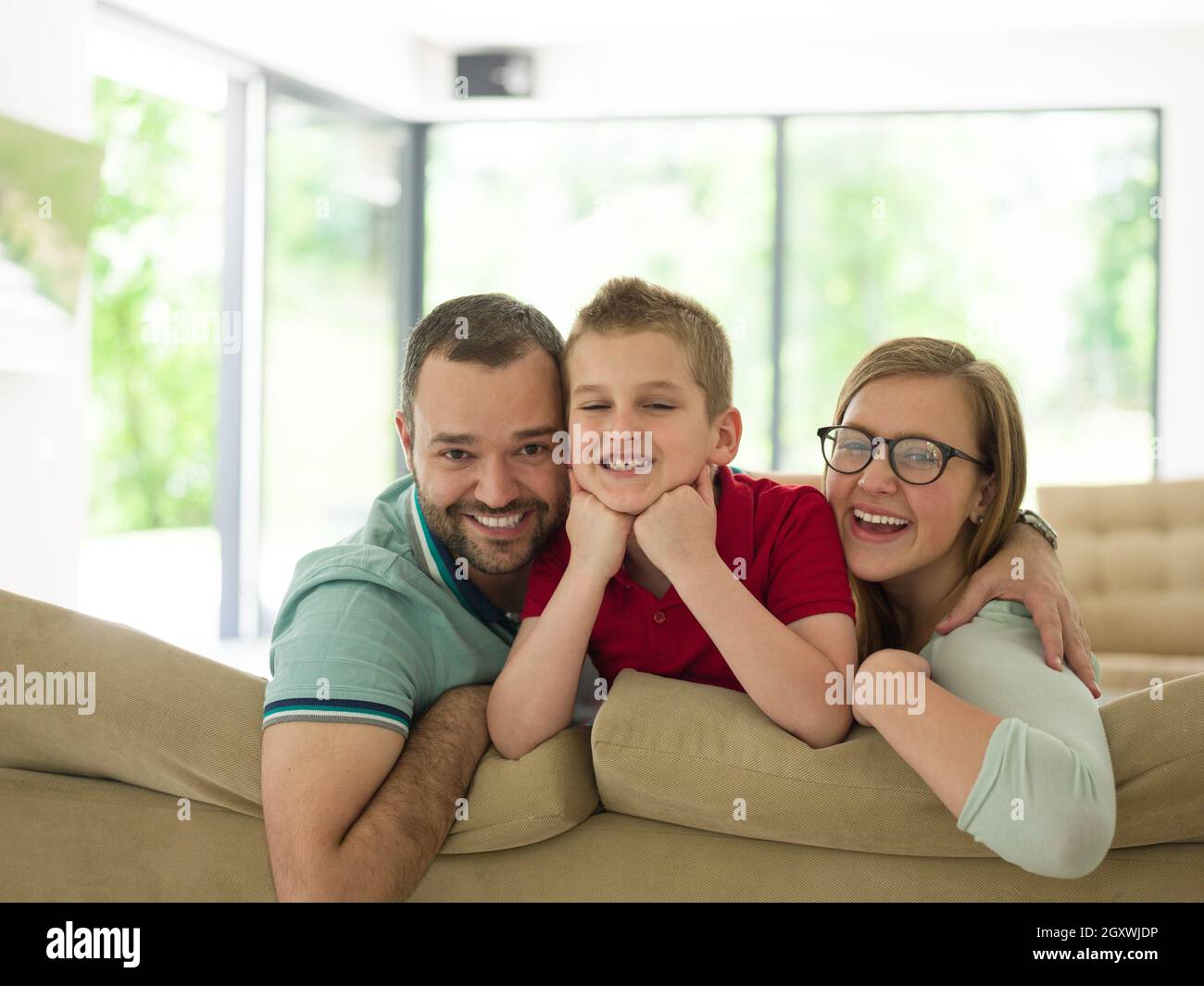 happy young family with little boy enjoys in the modern living room of ...