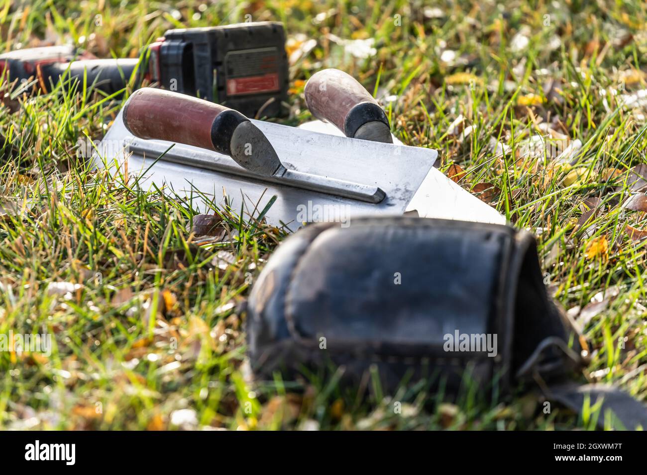 Cement Trowels And Tools On Grass At Construction Site Stock Photo - Alamy