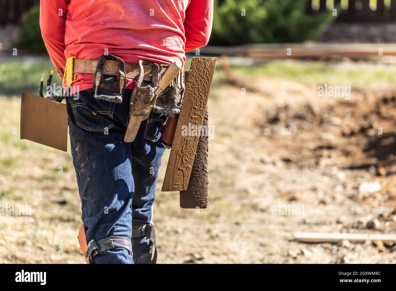 Cement Construction Worker With Toolbelt Holding Various Trowels and ...