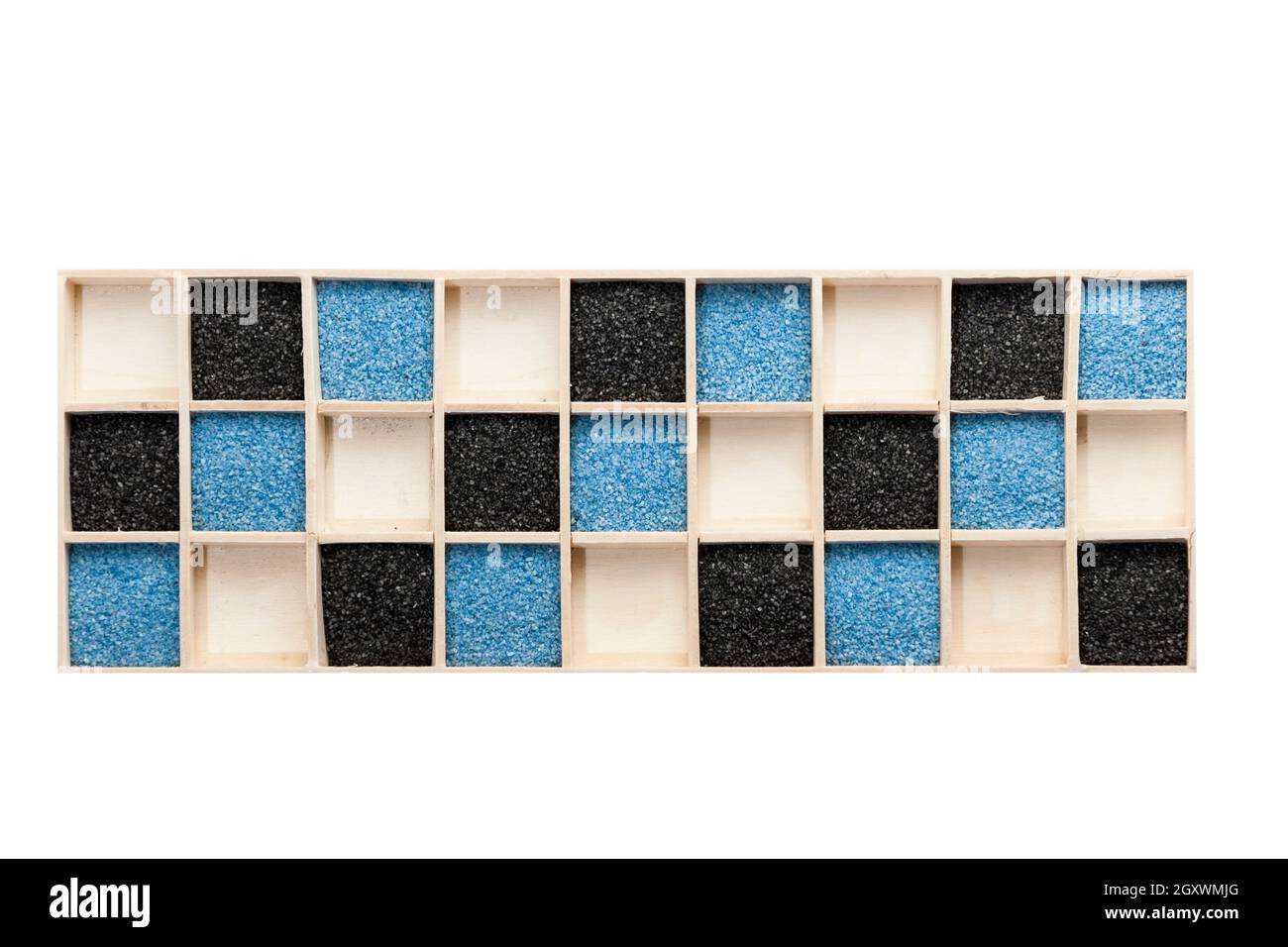 Wooden box with square compartments partly filled with blue or black ...