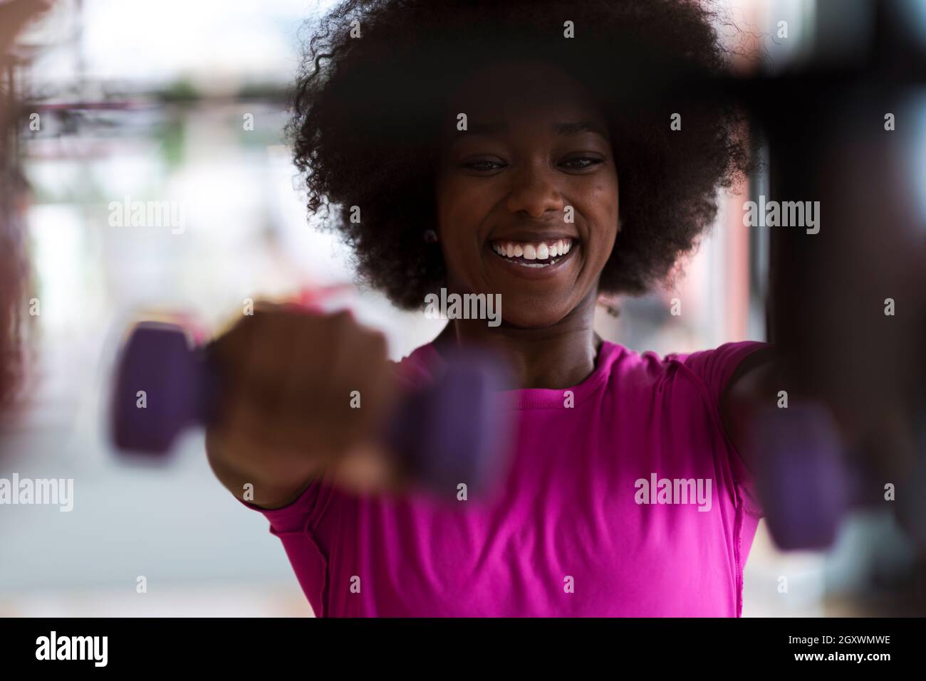 happy healthy african american woman working out in a crossfit gym on ...