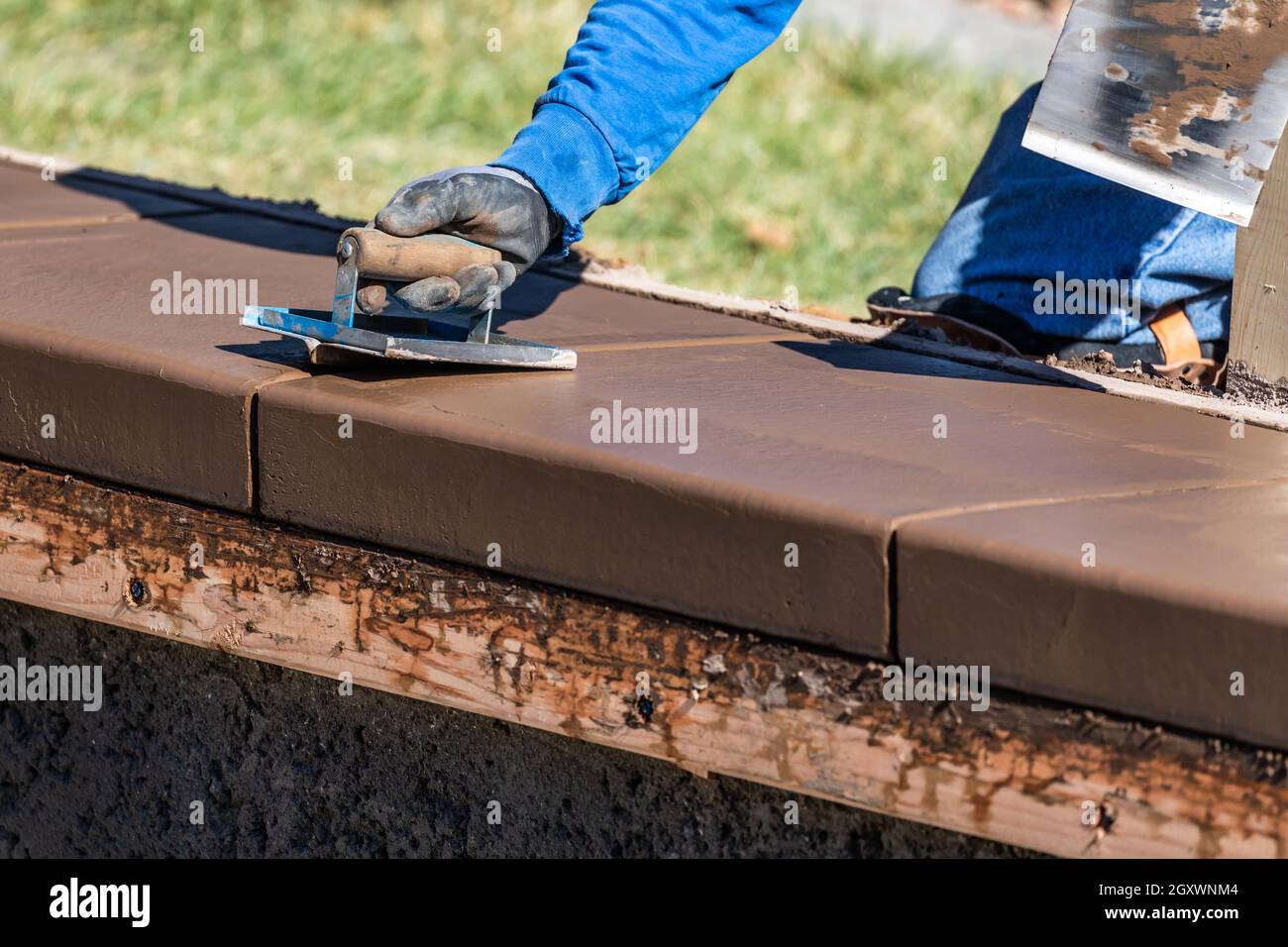 Construction Worker Using Hand Groover On Wet Cement Forming Coping ...