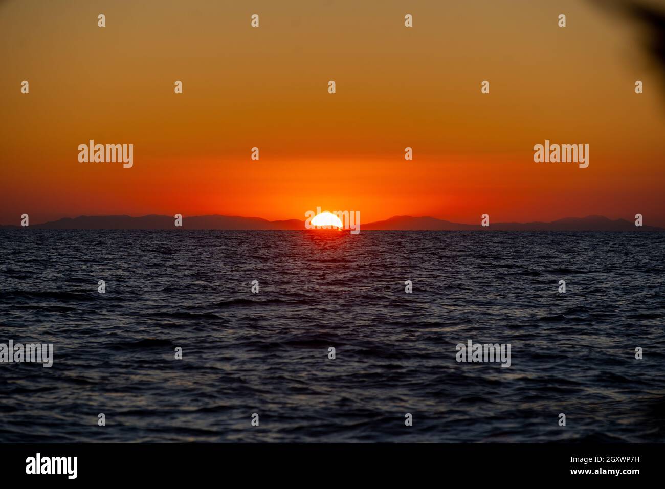 Susnet at the centre of Aegean,Greece Stock Photo - Alamy