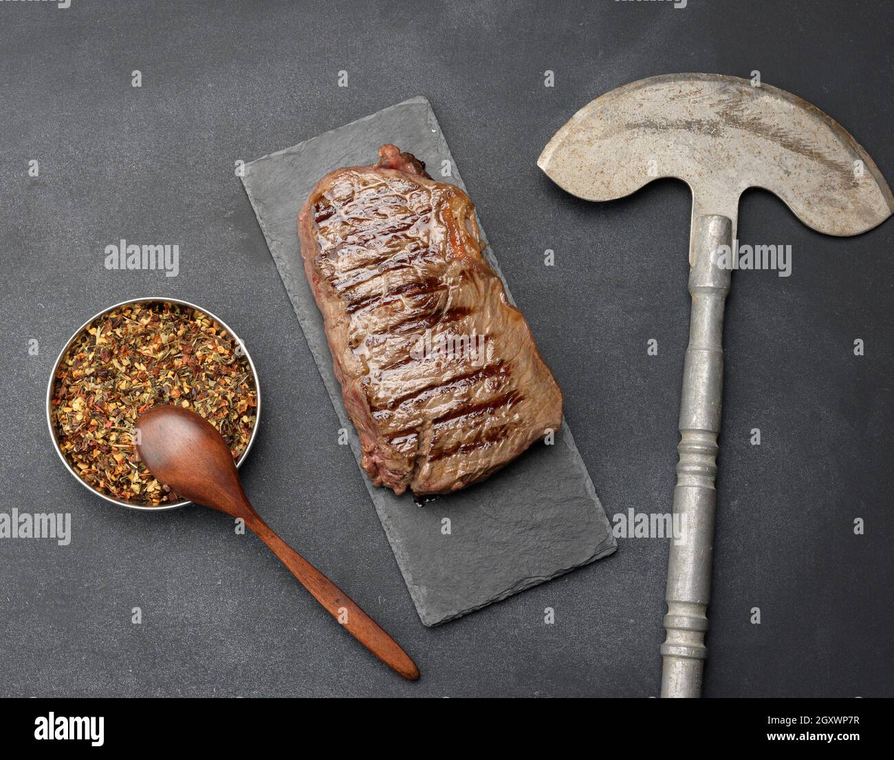 whole classic roast piece of beef on a black board, top view. Meat ...