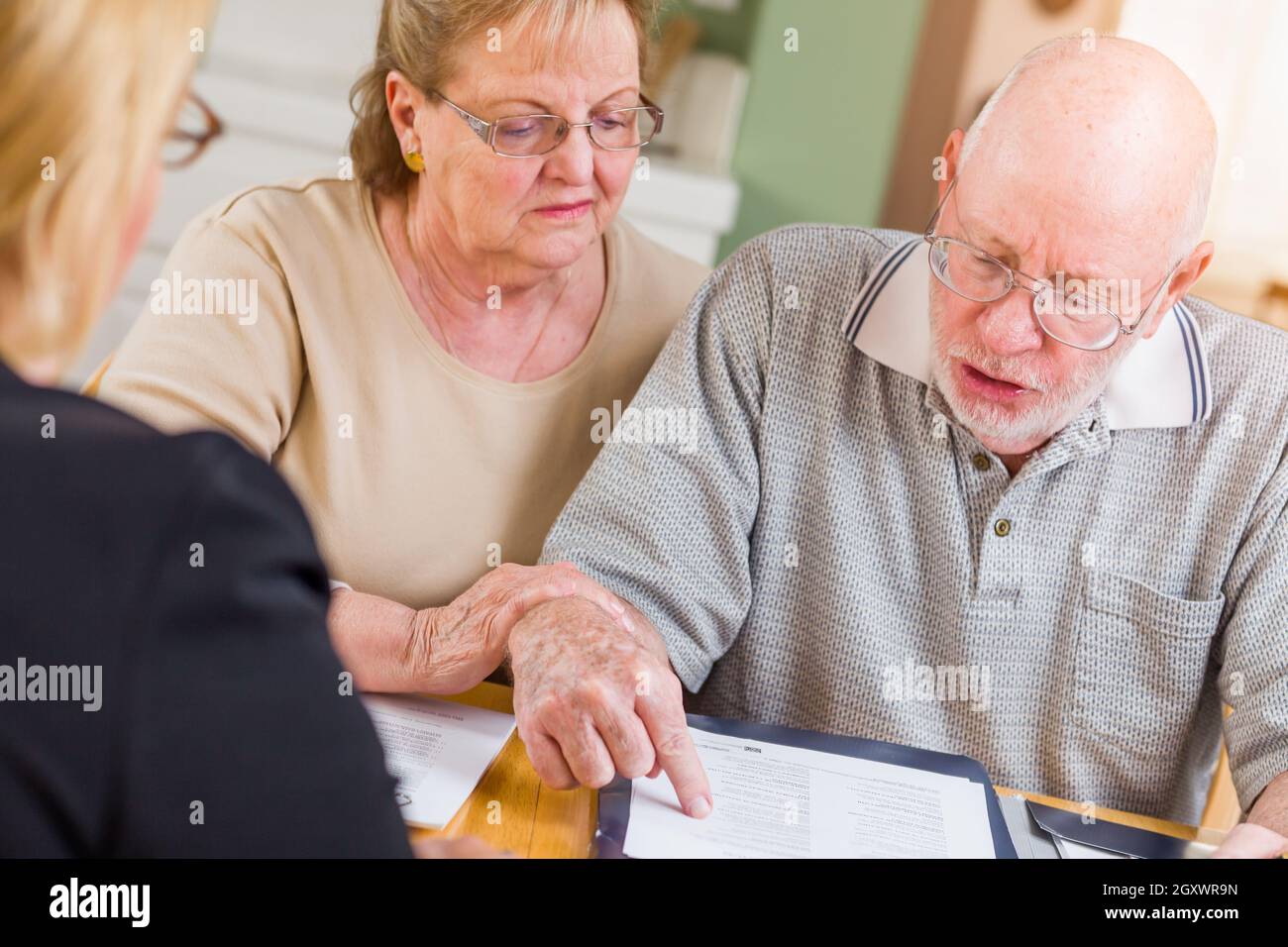 Senior couple signing documents hi-res stock photography and images - Alamy