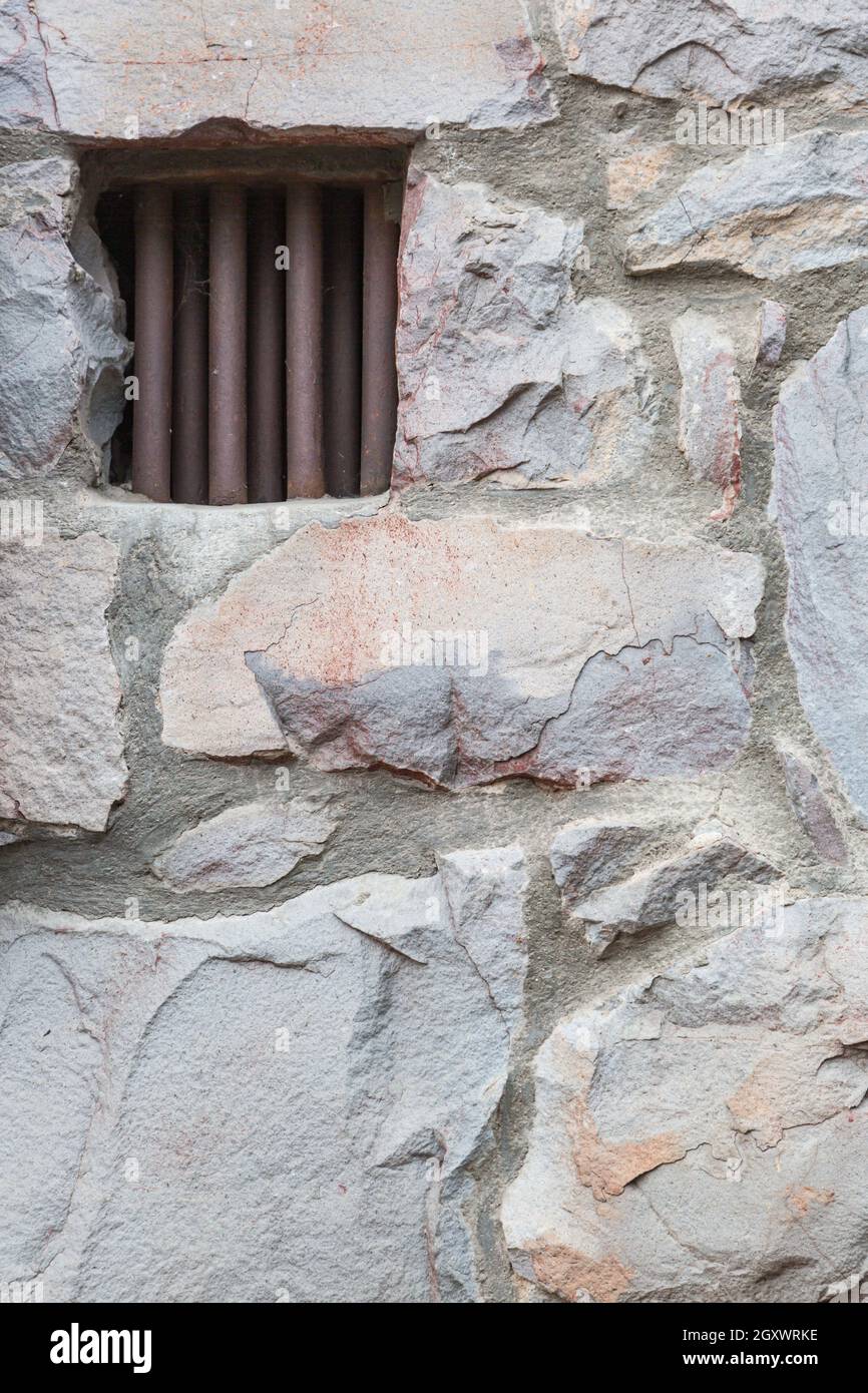 Old Stone Wall With Small Iron Barred Prison Cell Window Stock Photo ...