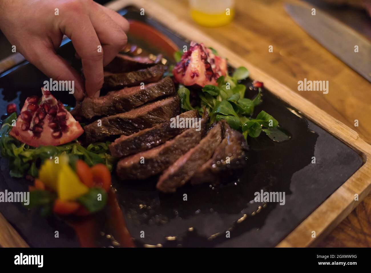 closeup of Chef hands in hotel or restaurant kitchen preparing beef ...