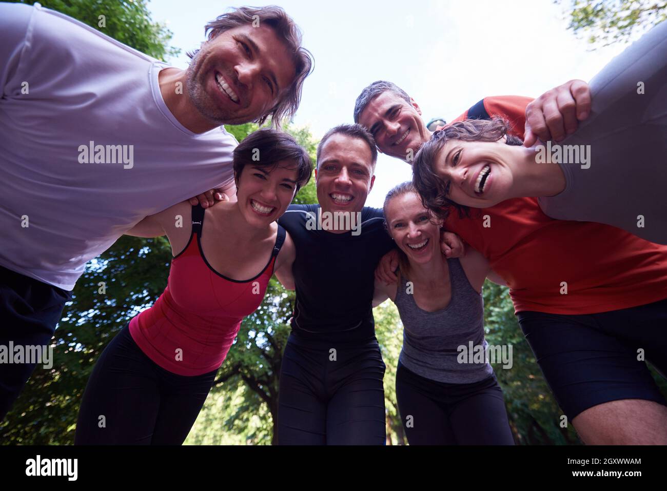 jogging people group, friends have fun, hug and stack hands together ...