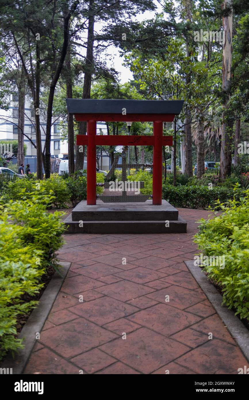 Traditional Japanese gate and symbol surrounded by trees in park Stock ...