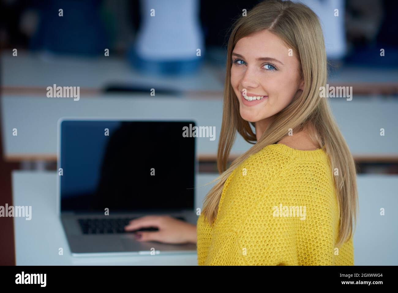 portrait of happy smilling student girl at tech classroom with laptop ...