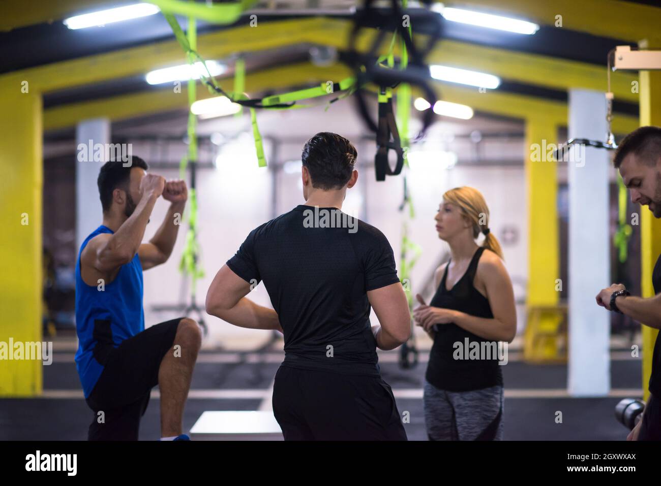 group of young healthy athletic people training jumping on fit box at ...