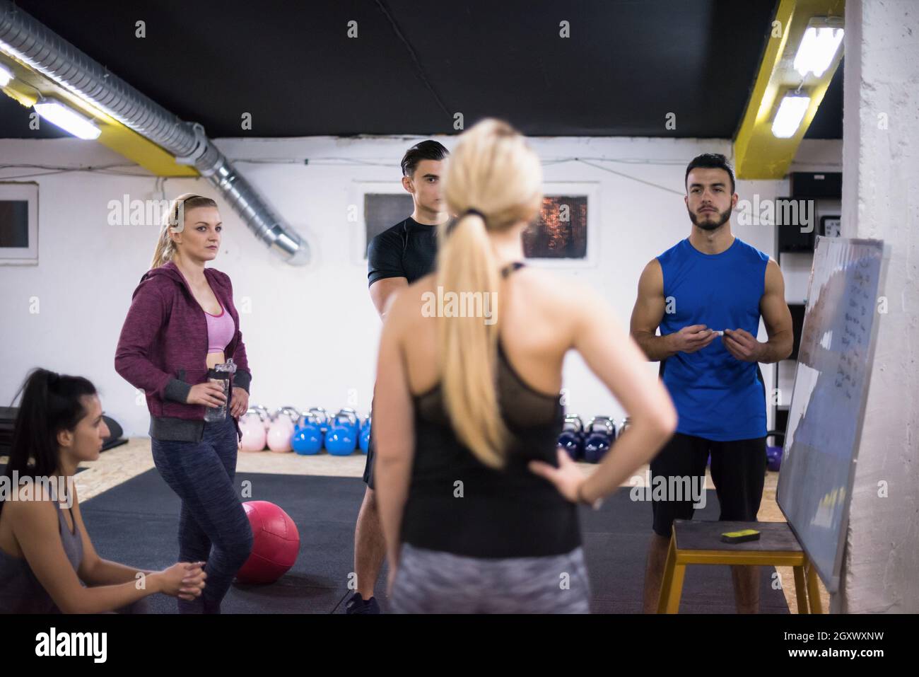 Training course.group of young athletes getting instructions from ...