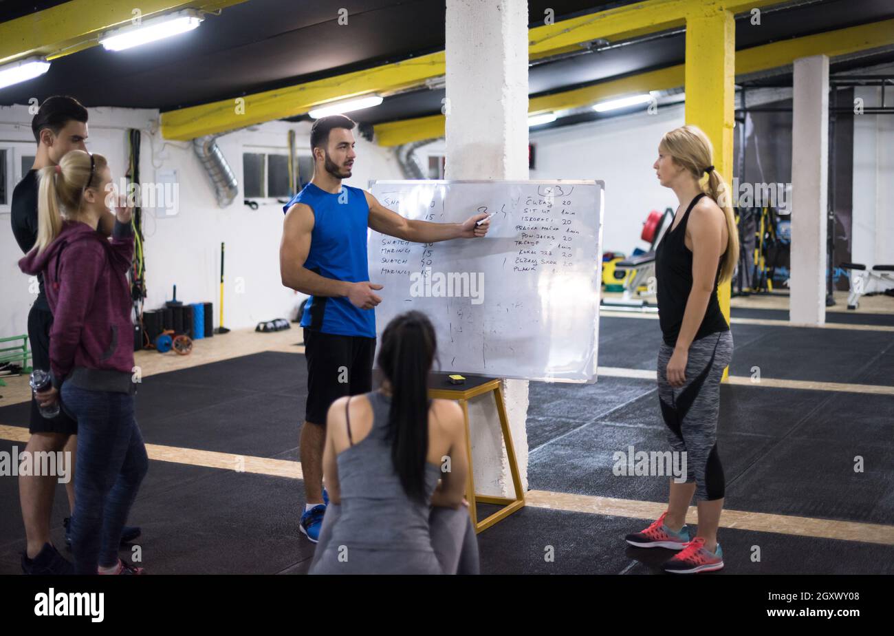 Training course.group of young athletes getting instructions from ...