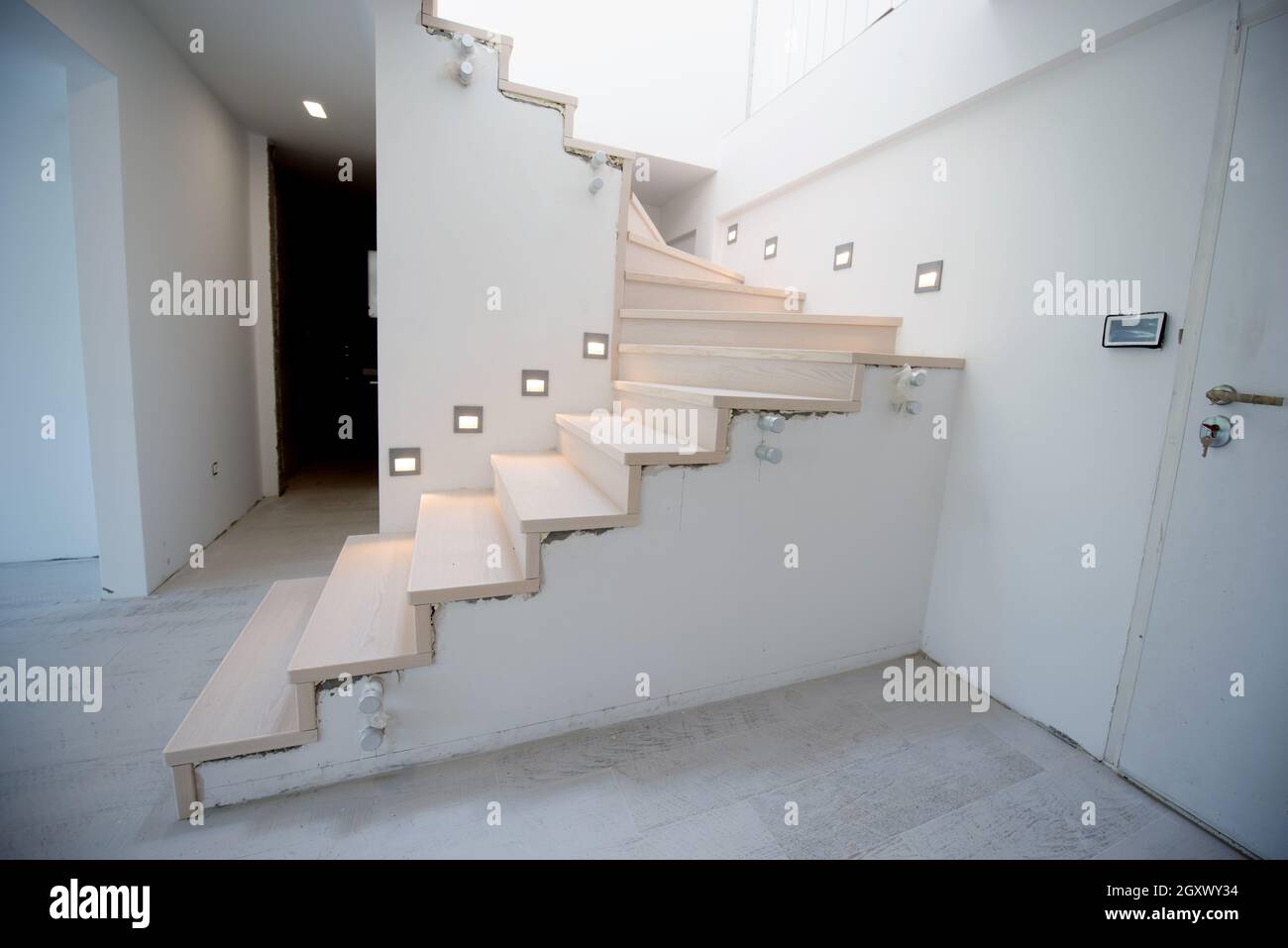 stylish interior with wooden stairs in big modern two level luxury ...