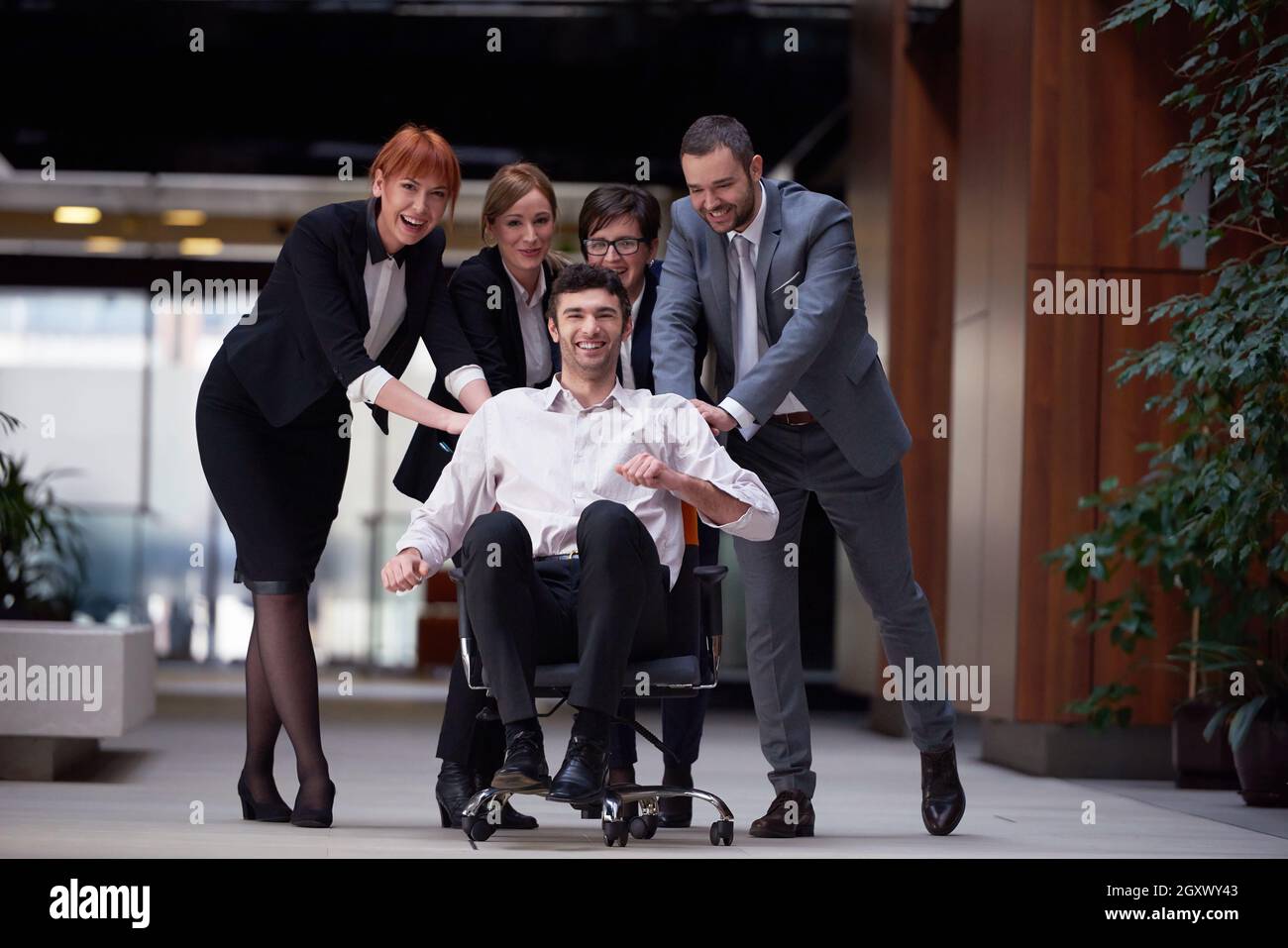 business people group at modern office indoors have fun and push office ...