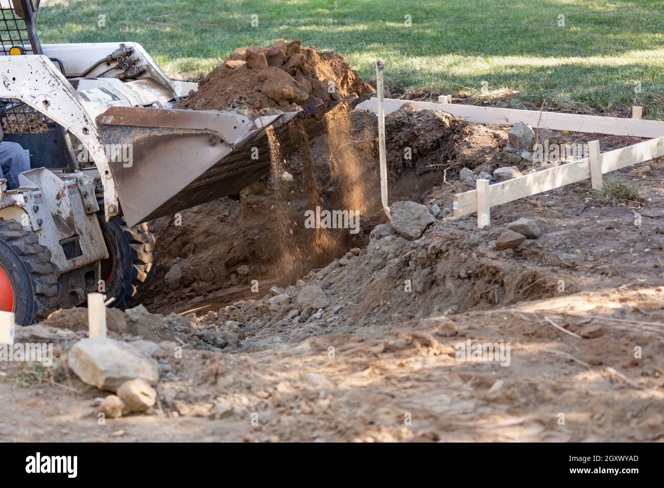 Small Bulldozer Digging In Yard For Pool Installation Stock Photo - Alamy