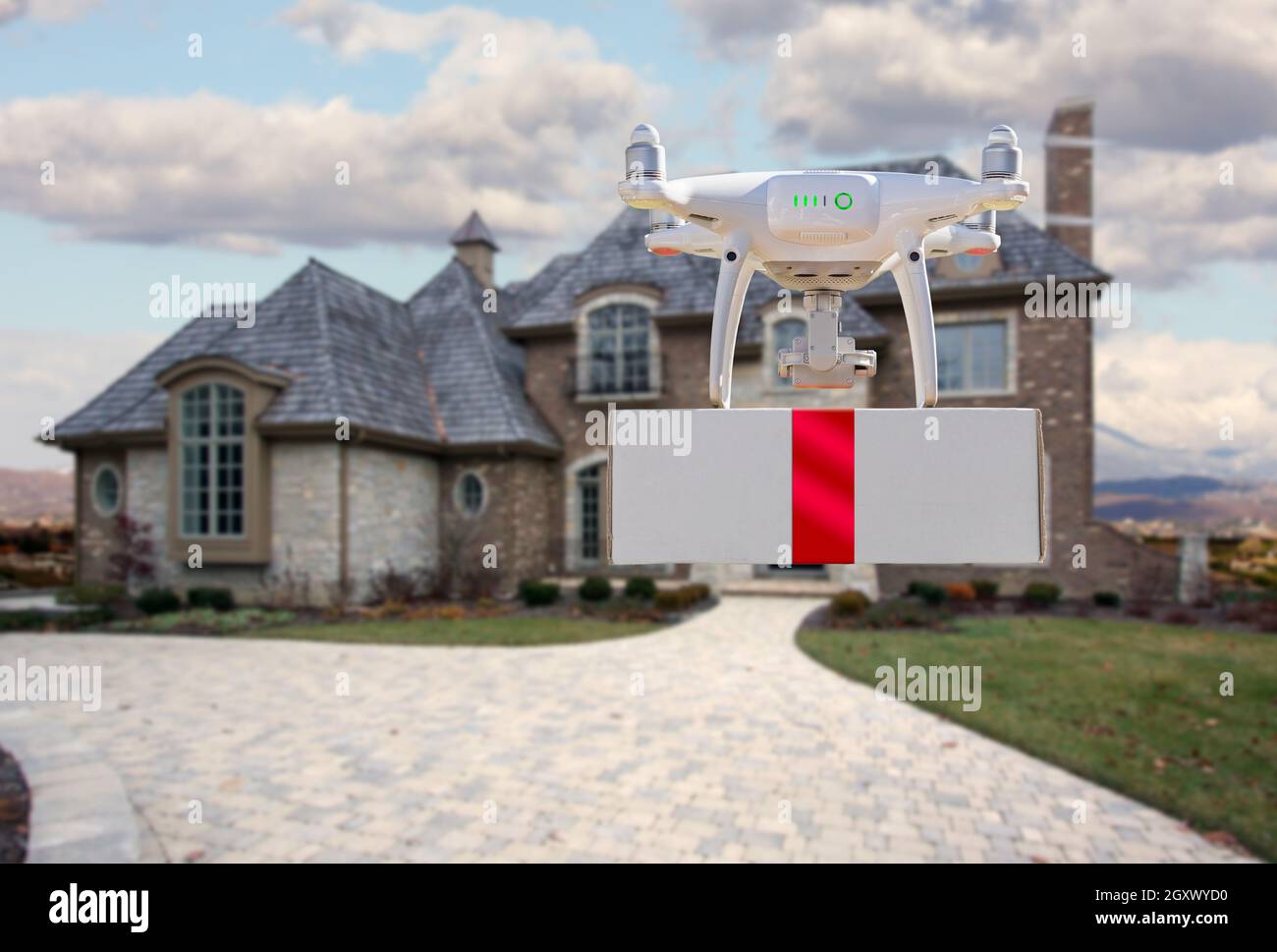 Unmanned Aircraft System (UAV) Quadcopter Drone Delivering Box With Red ...