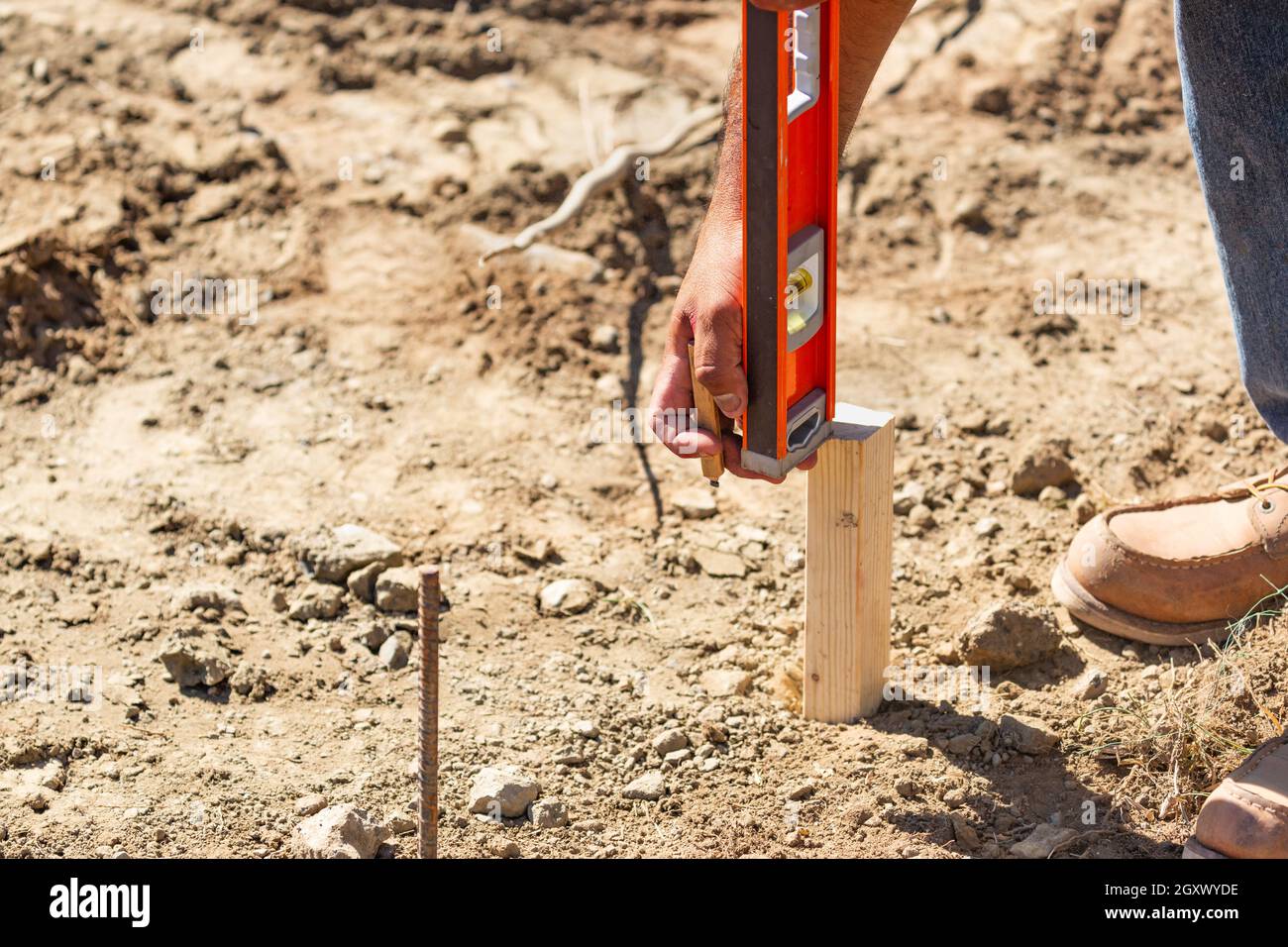 Worker Using Level At Construction Site Stock Photo - Alamy