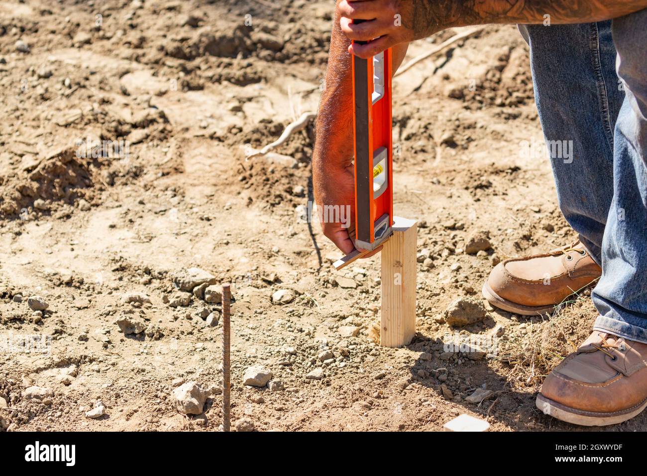 Worker Using Level At Construction Site Stock Photo - Alamy