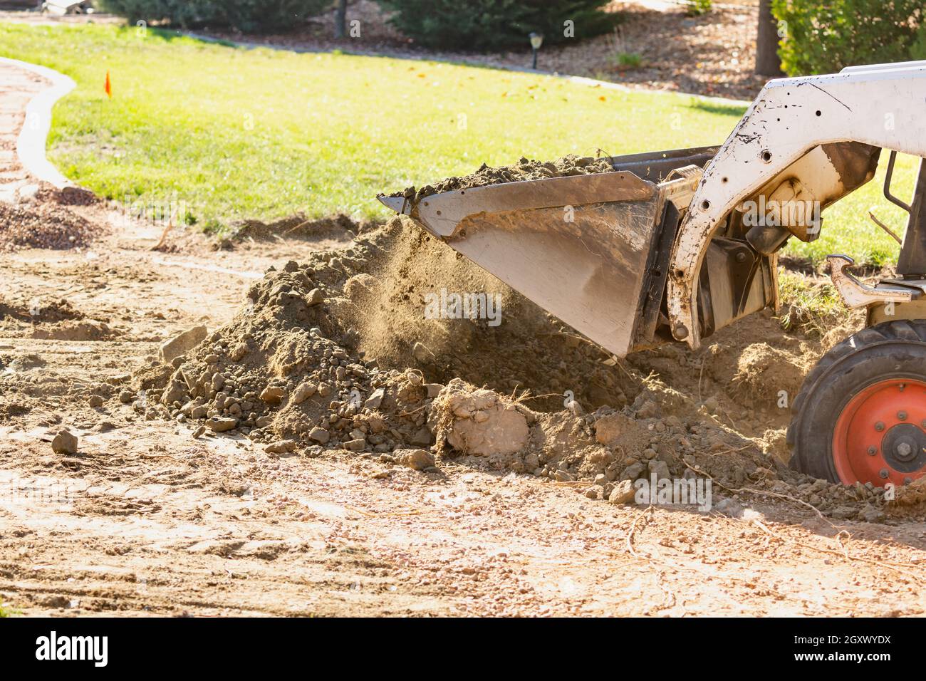 Small Bulldozer Digging In Yard For Pool Installation Stock Photo - Alamy