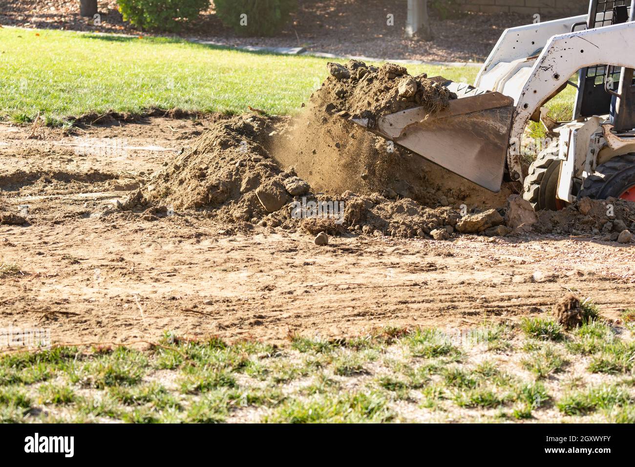 Small Bulldozer Digging In Yard For Pool Installation Stock Photo - Alamy