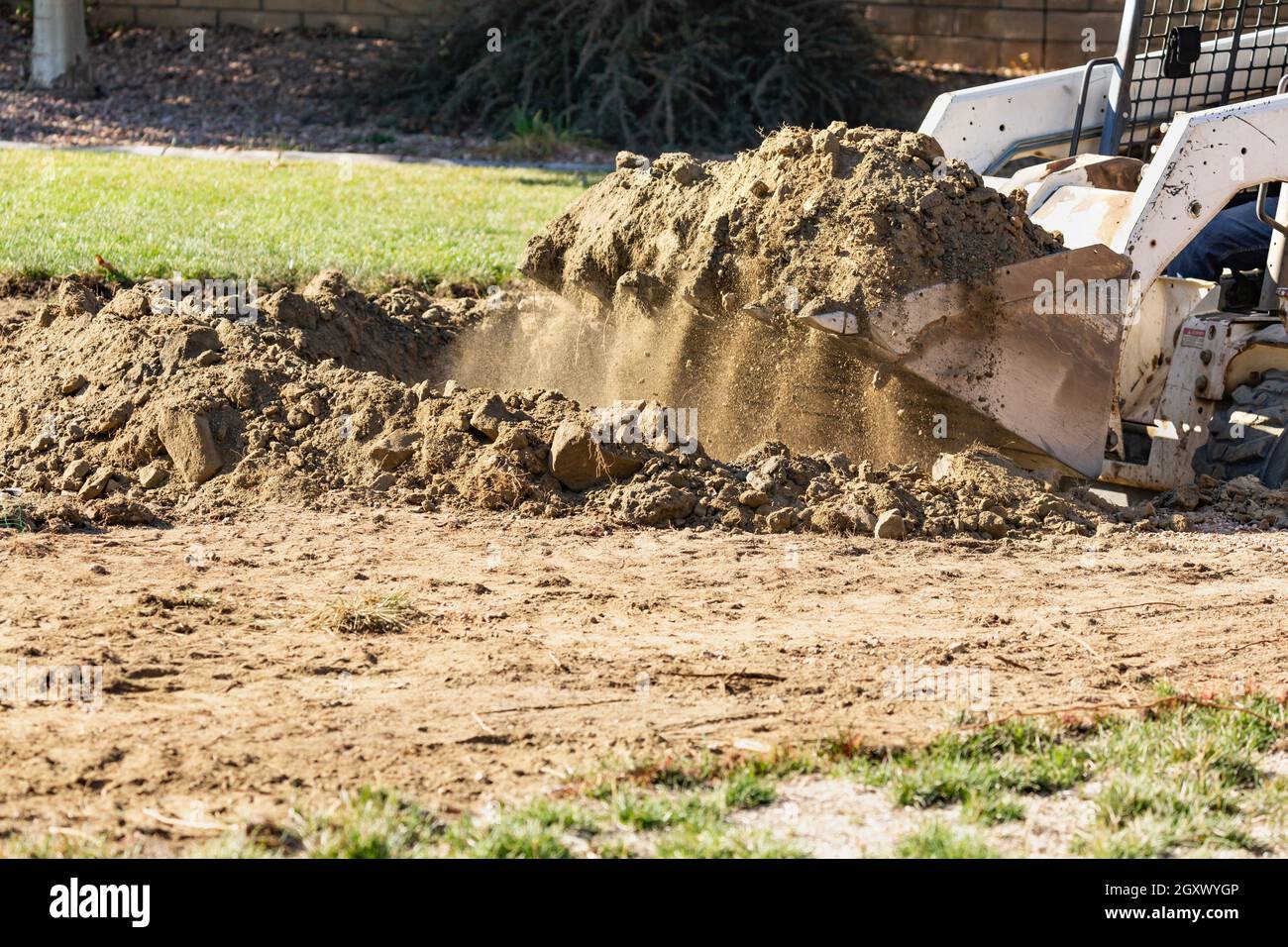 Small Bulldozer Digging In Yard For Pool Installation Stock Photo - Alamy
