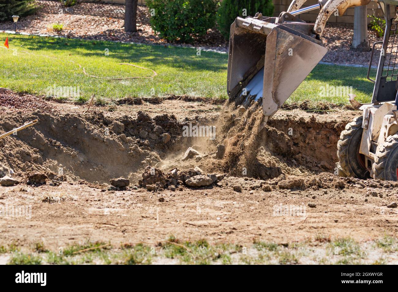 Small Bulldozer Digging In Yard For Pool Installation Stock Photo - Alamy