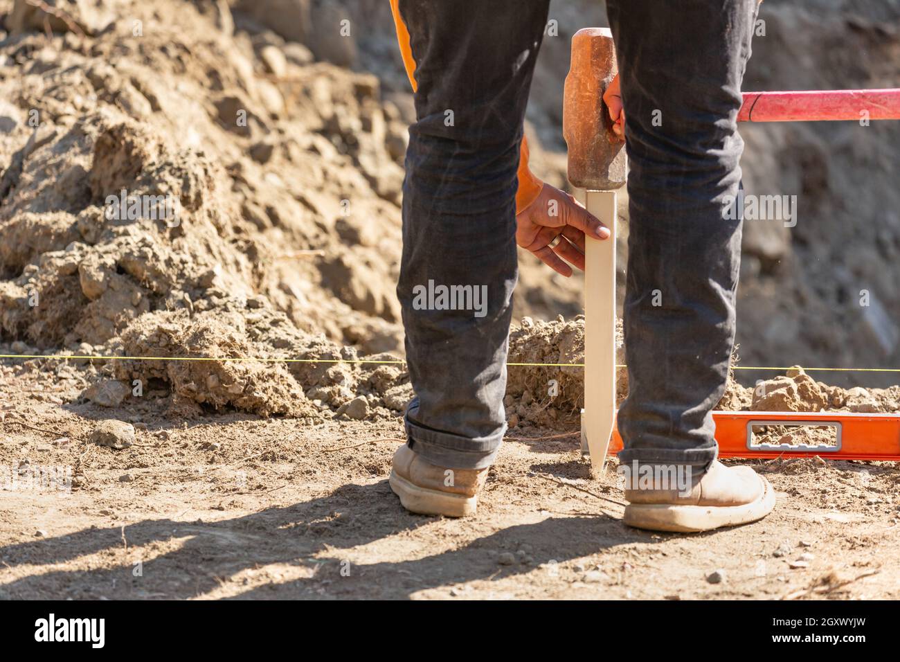 Worker Installing Stakes and Lumber Guides At Construction Site Stock ...