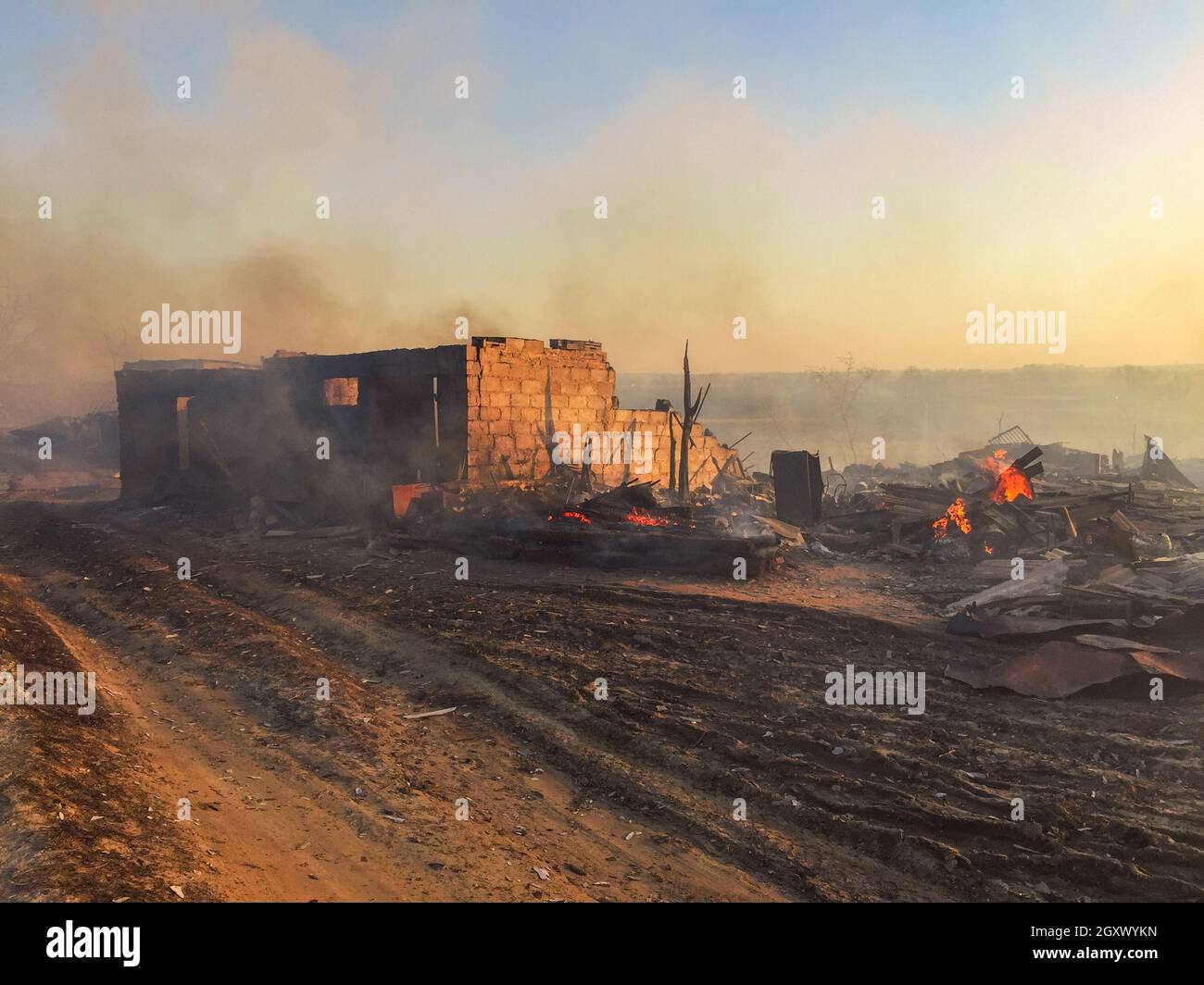 Building destroyed by fire. Flames and smoke still visible Stock Photo ...