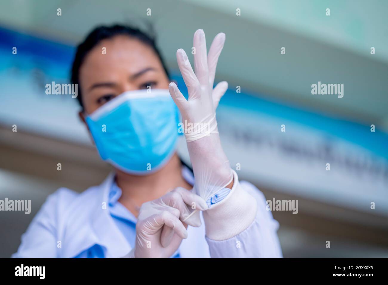 Doctor or nurses showing how to wearing face mask and Medical gloves ...