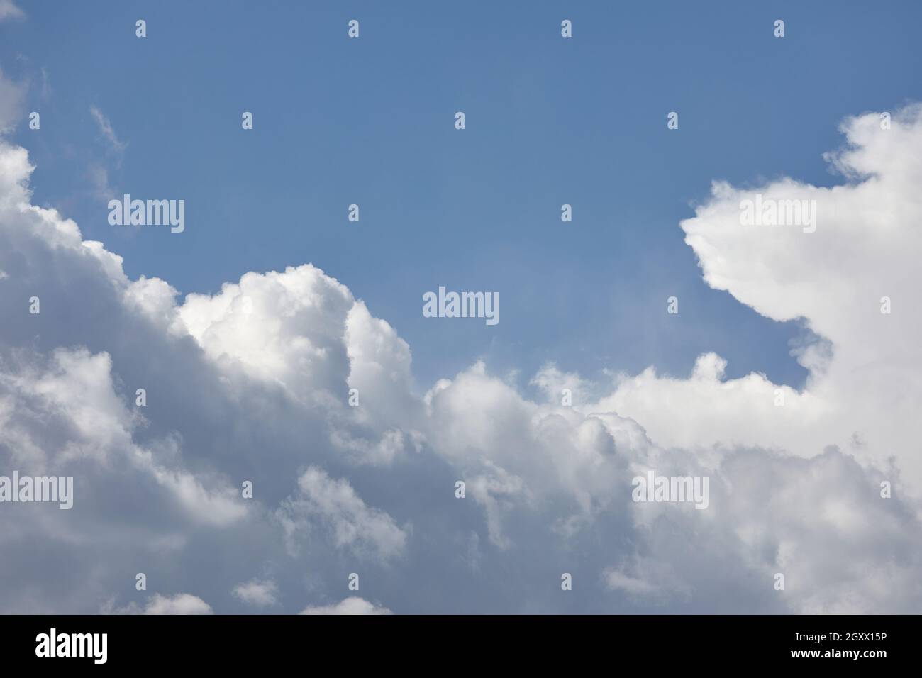 Small white clouds in bright blue sky Stock Photo - Alamy