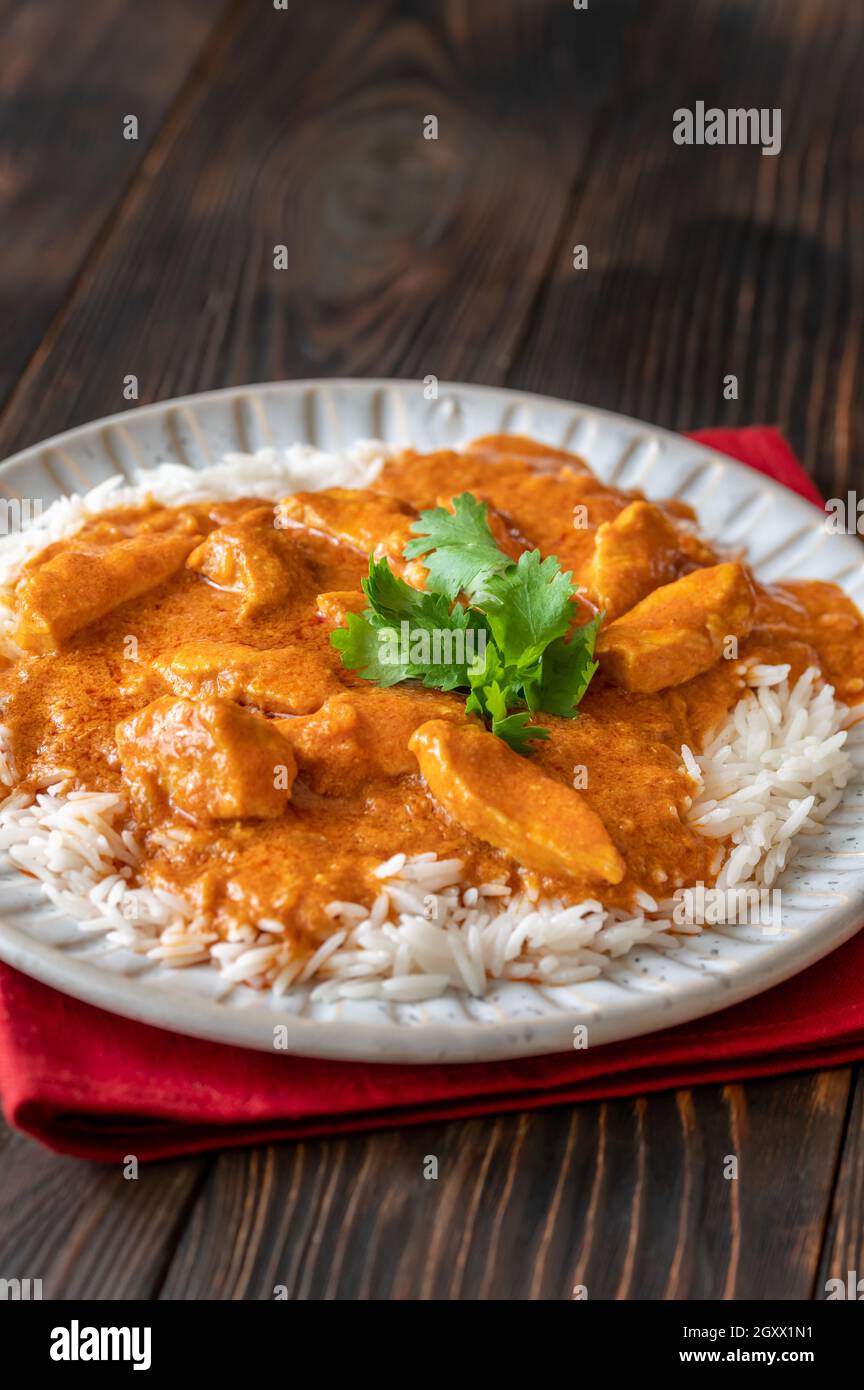 Bowl of Thai red chicken curry garnished with white rice Stock Photo ...
