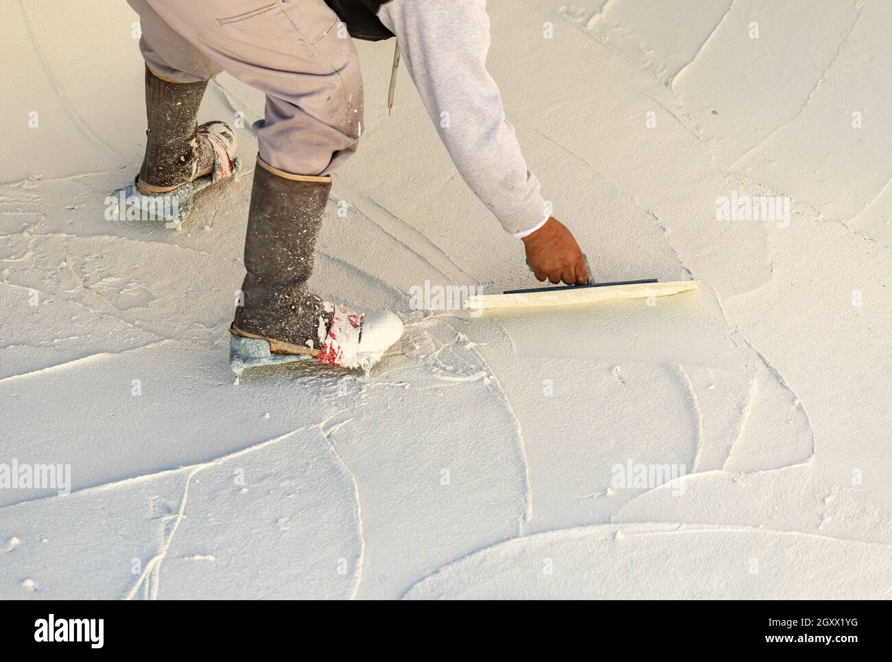 Worker Wearing Spiked Shoes Smoothing Wet Pool Plaster With Trowel ...