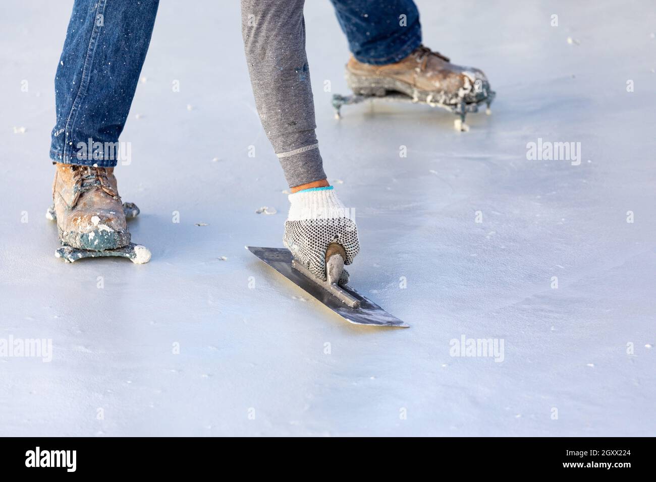 Worker Wearing Spiked Shoes Smoothing Wet Pool Plaster With Trowel ...