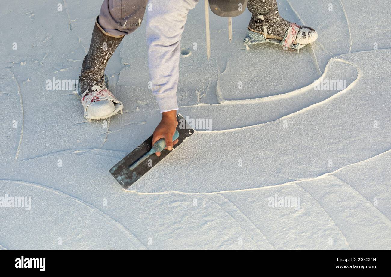 Worker Wearing Spiked Shoes Smoothing Wet Pool Plaster With Trowel ...
