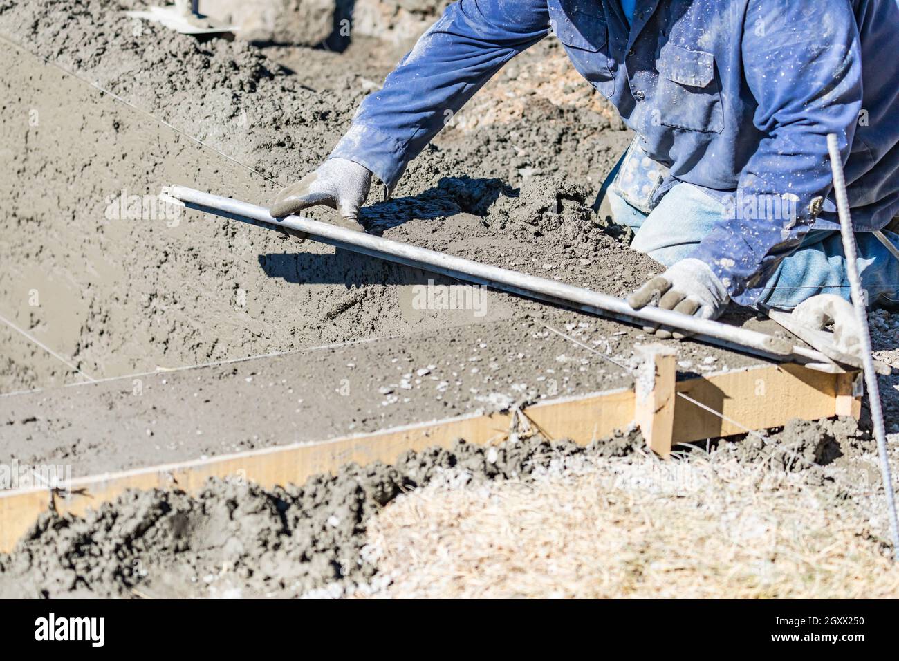 Pool Construction Worker Working With A Smoother Rod On Wet Concrete ...