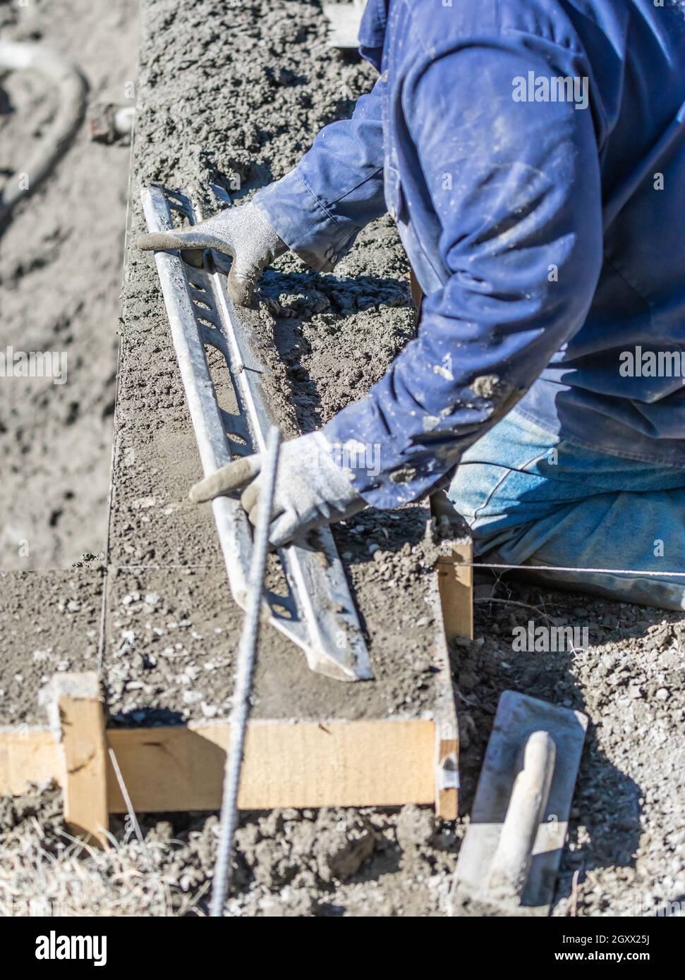 Pool Construction Worker Working With A Smoother Rod On Wet Concrete ...
