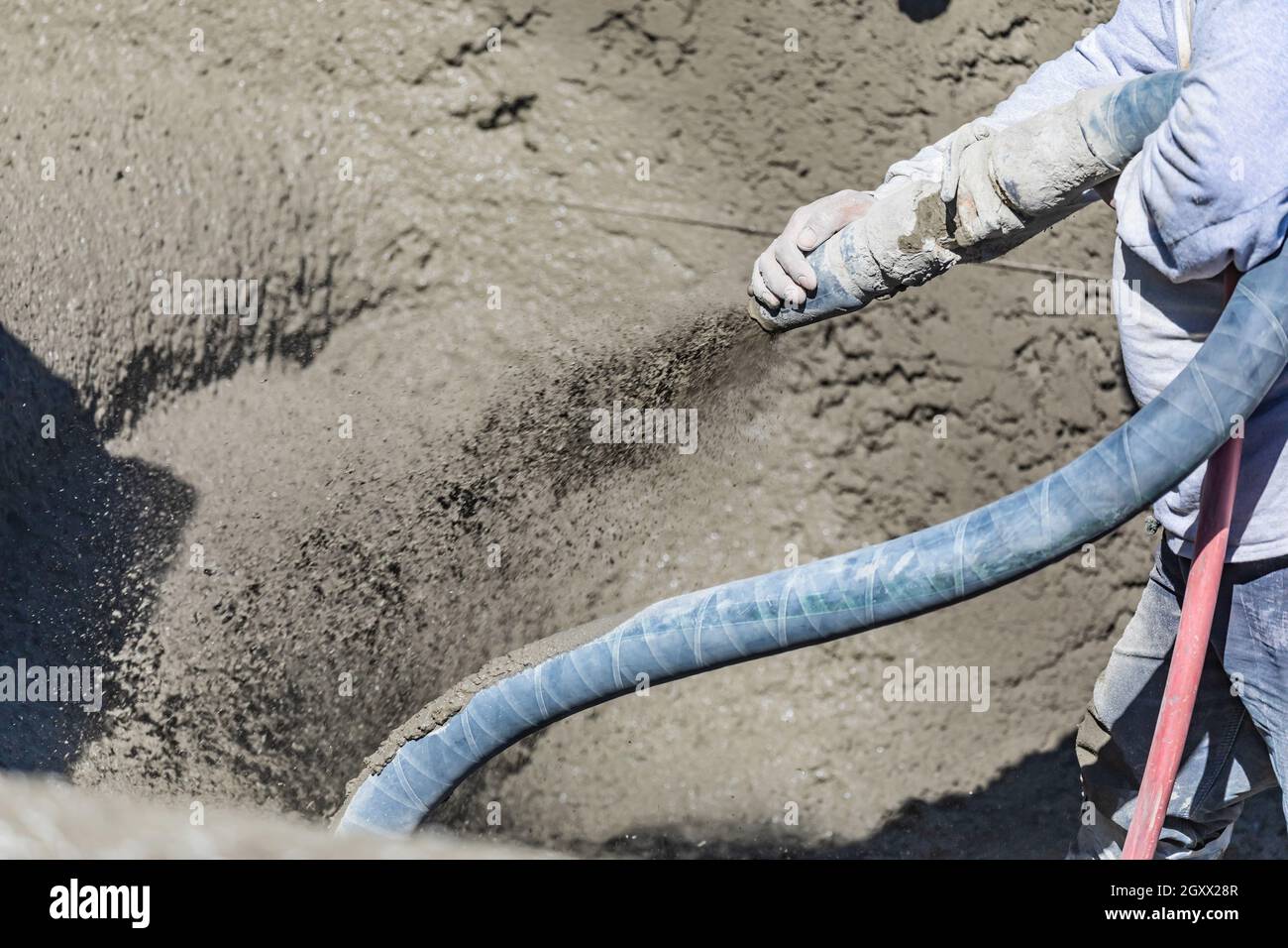 Pool Construction Worker Shooting Concrete, Shotcrete or Gunite Through ...