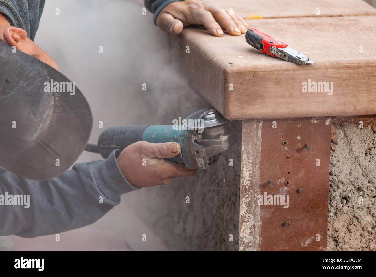 Construction Worker Using Grinder At Construction Site Stock Photo - Alamy