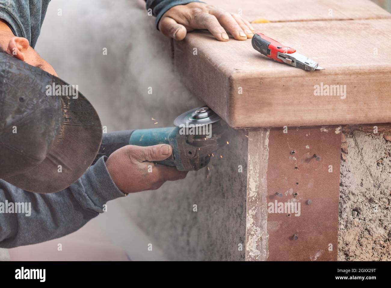 Construction Worker Using Grinder At Construction Site Stock Photo - Alamy