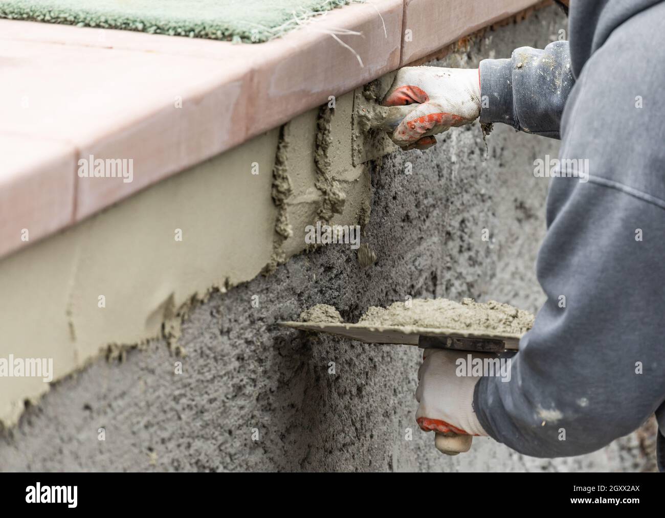 Tile Worker Applying Cement with Trowel at Pool Construction Site Stock ...