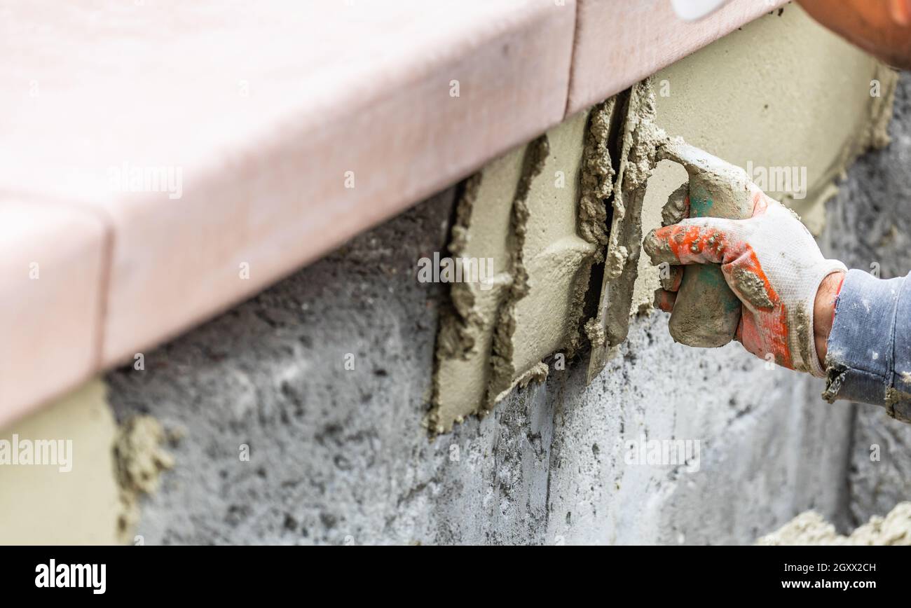 Tile Worker Applying Cement with Trowel at Pool Construction Site Stock ...