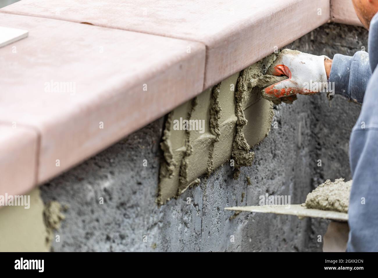Tile Worker Applying Cement with Trowel at Pool Construction Site Stock ...