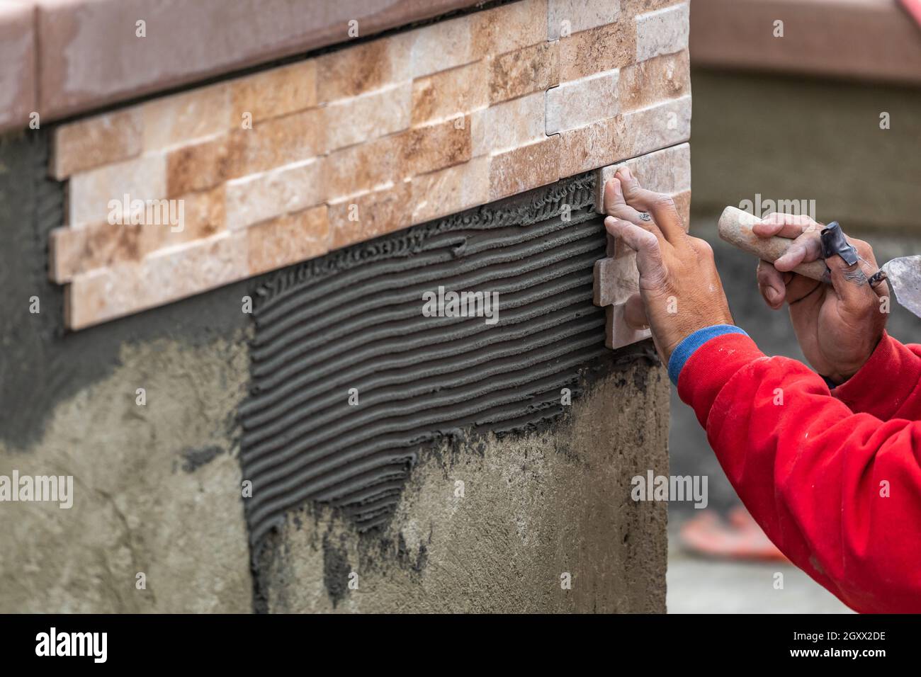Worker Installing Wall Tile at Construction Site Stock Photo - Alamy