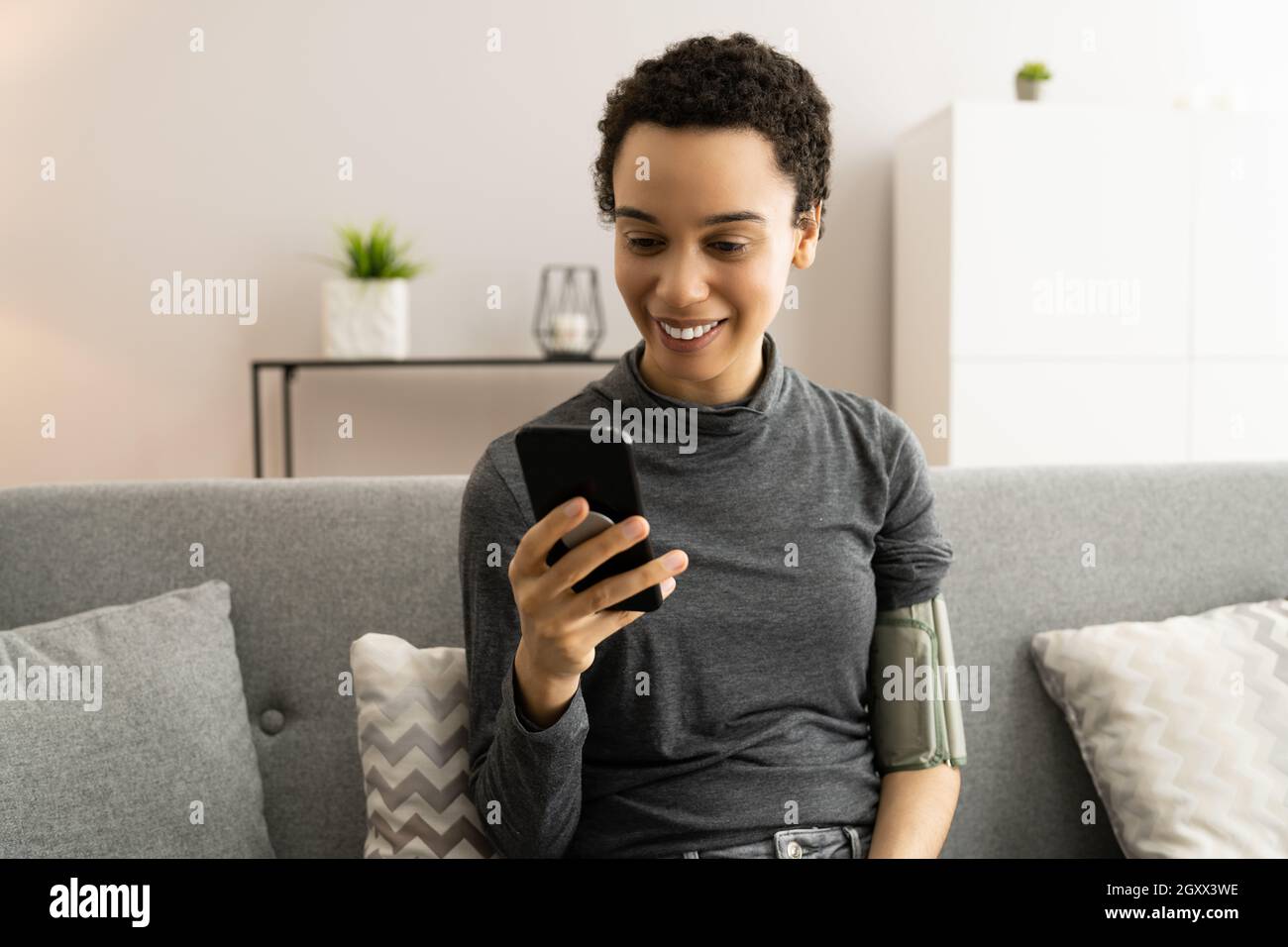 Blood Pressure Check Using Smart Monitor. African Patient Woman Stock ...