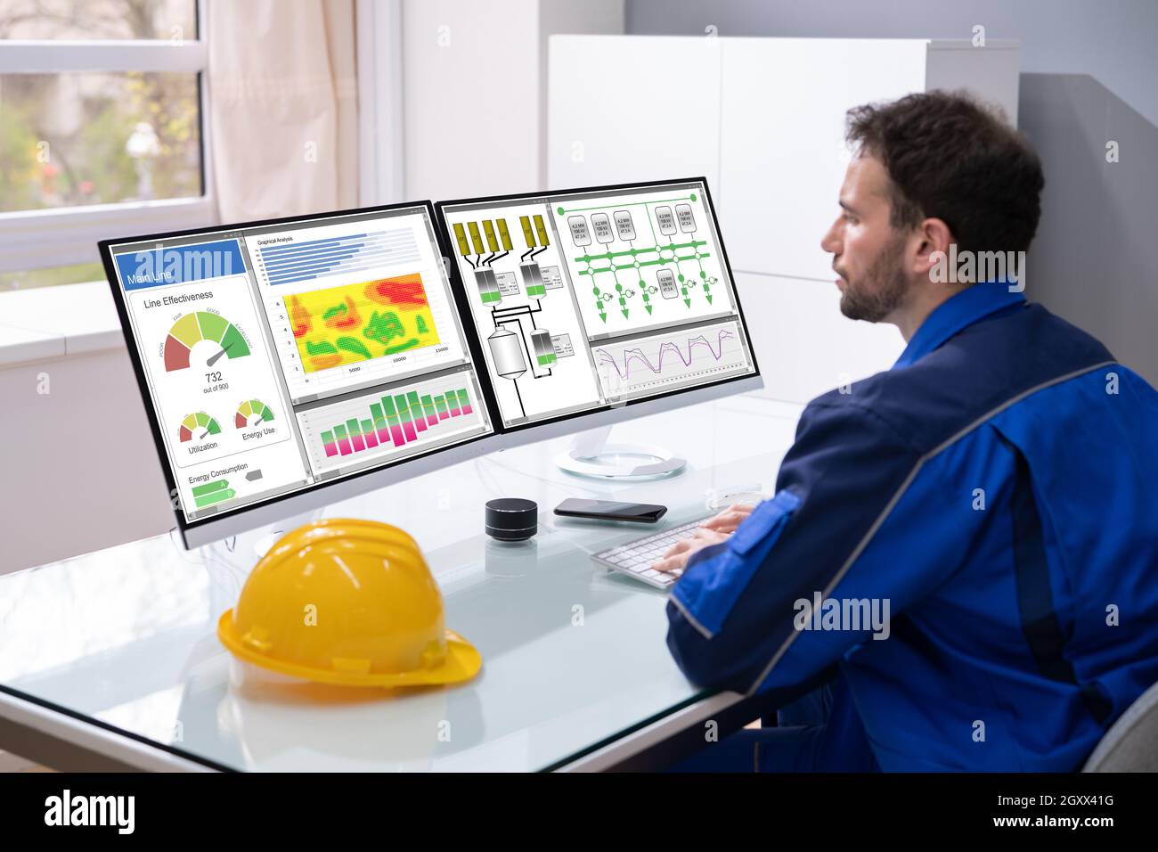 Industrial Engineer Sitting At Workplace Behind Computer Monitor Stock ...