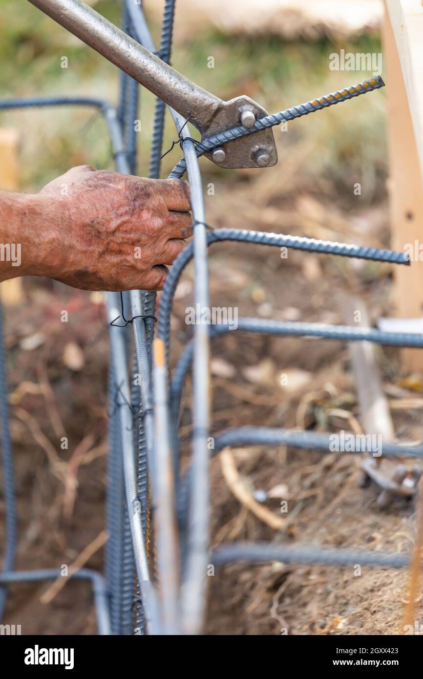 Worker Using Tools To Bend Steel Rebar At Construction Site Stock Photo ...