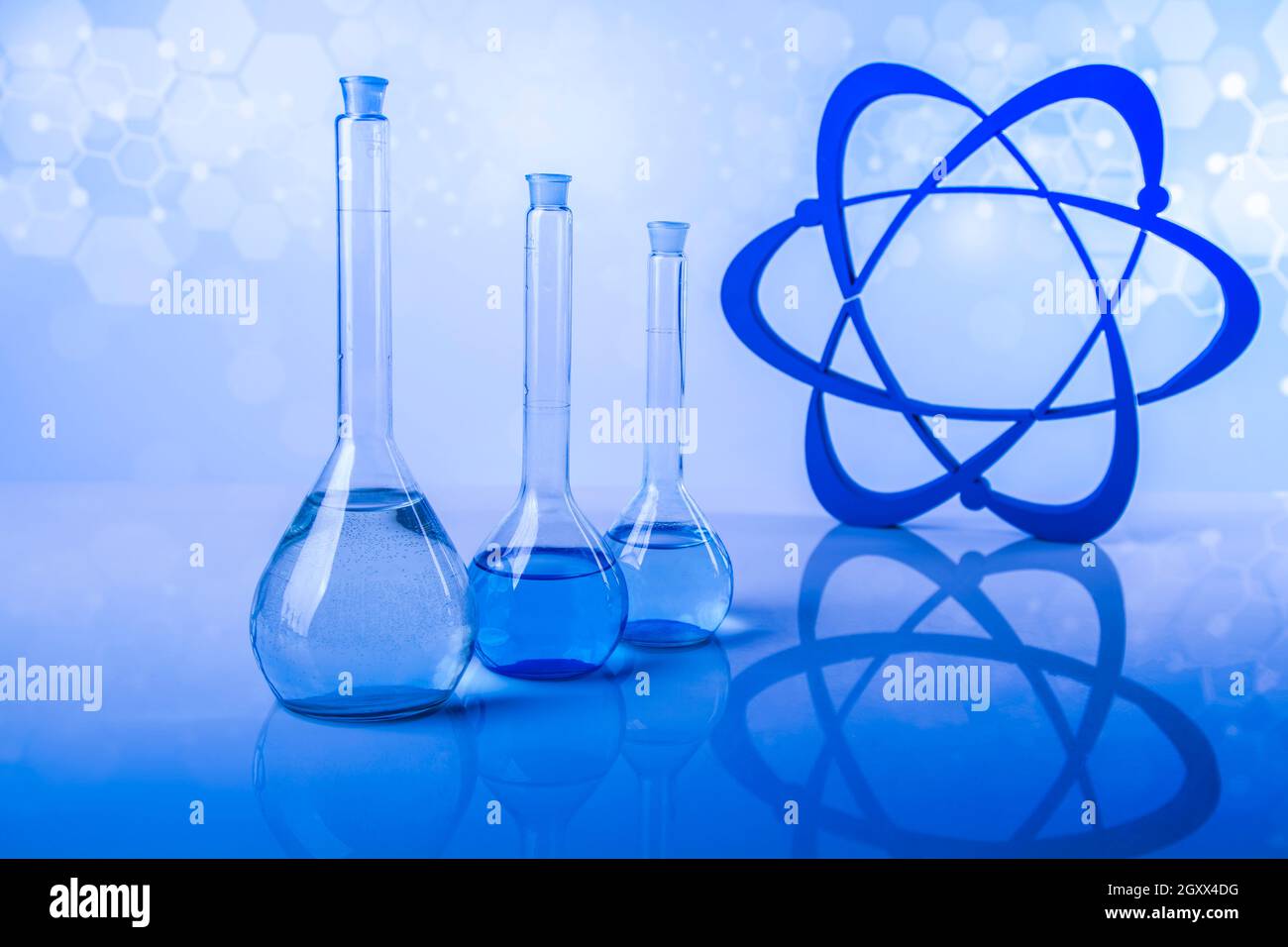 Atom, Laboratory beakers, microscope, blue background Stock Photo - Alamy